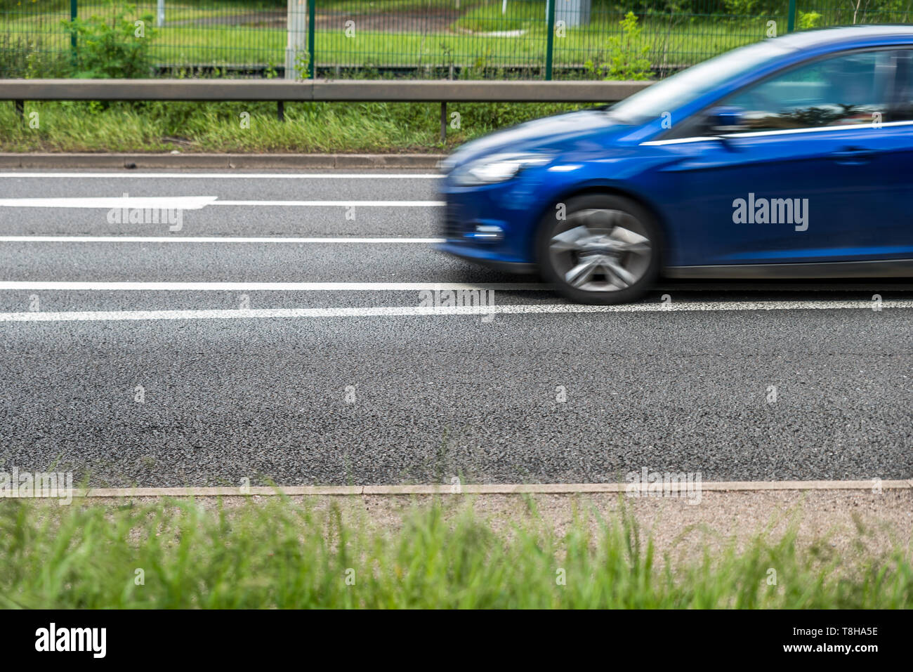 blue car on uk motorway in fast motion Stock Photo - Alamy