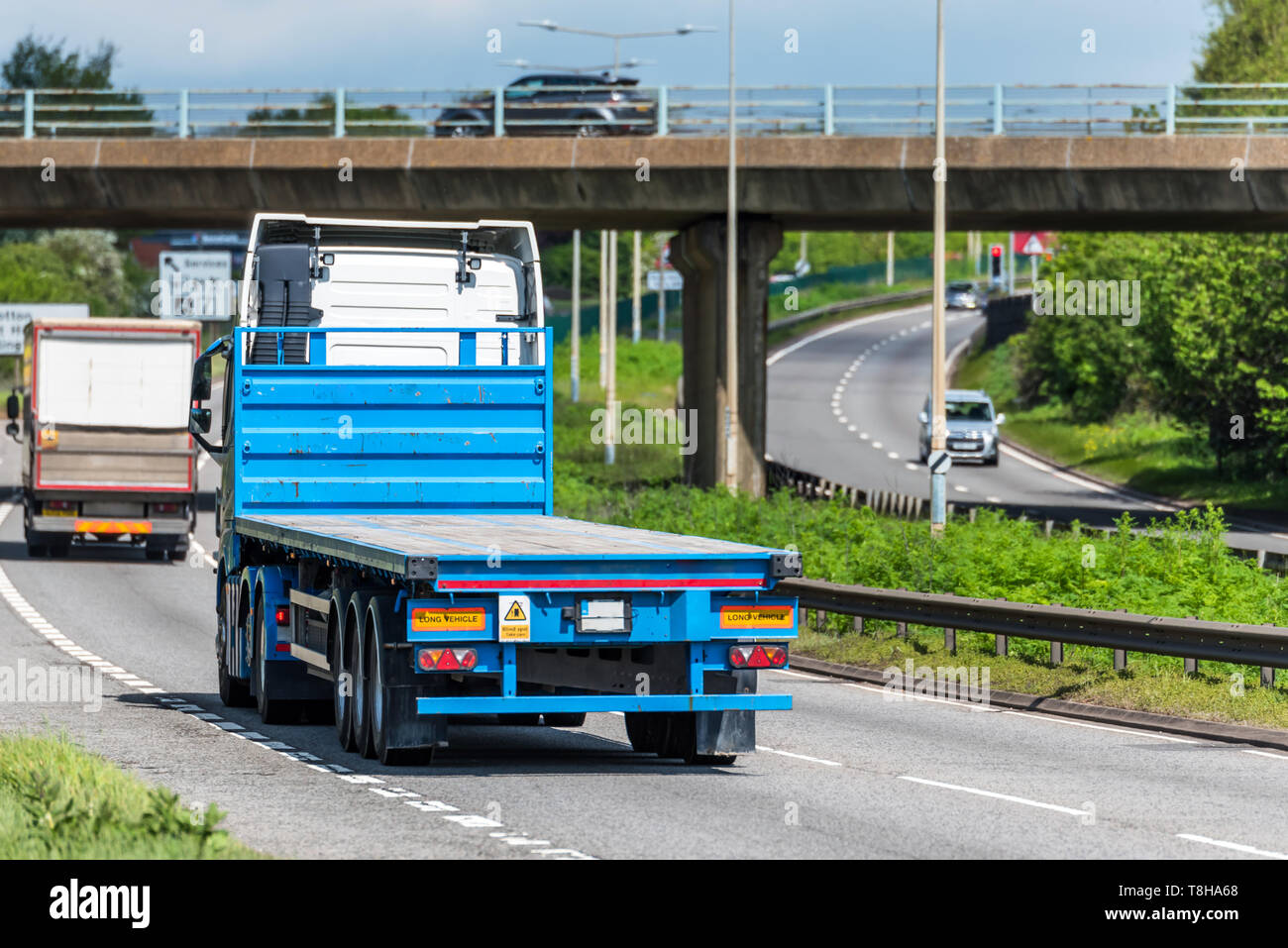 flatbed lorry truck on uk motorway in fast motion Stock Photo - Alamy