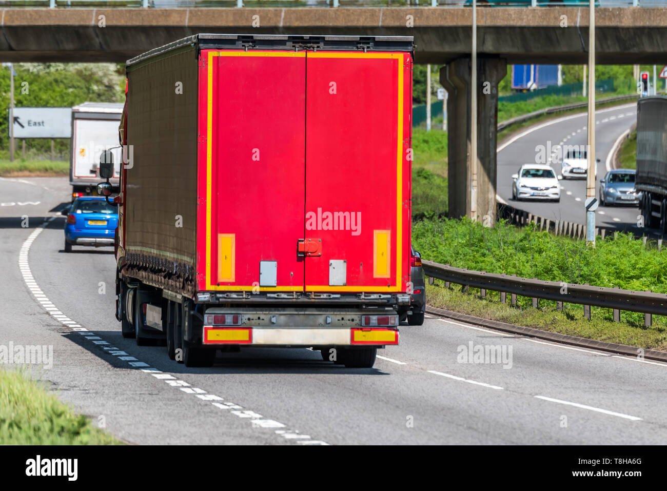 red curtain side lorry truck on uk motorway in fast motion Stock Photo ...