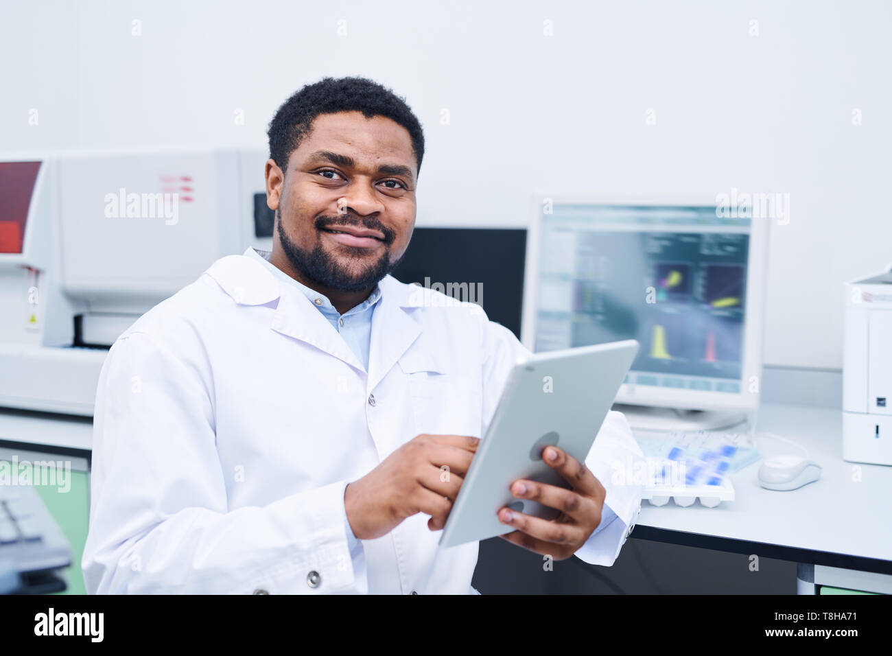 Confident black medical expert in laboratory Stock Photo - Alamy
