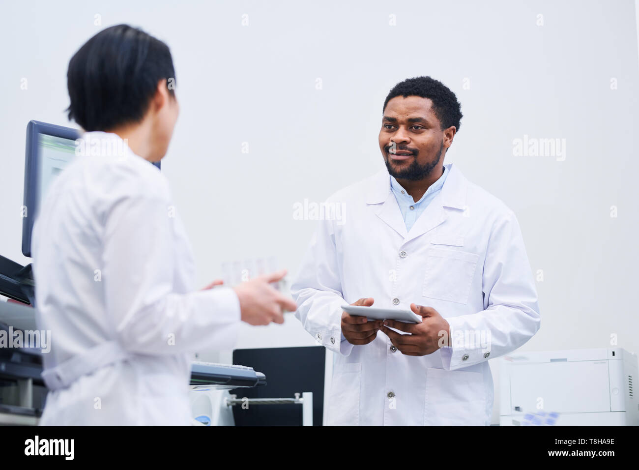 Young multiethnic colleagues looking hi-res stock photography and ...
