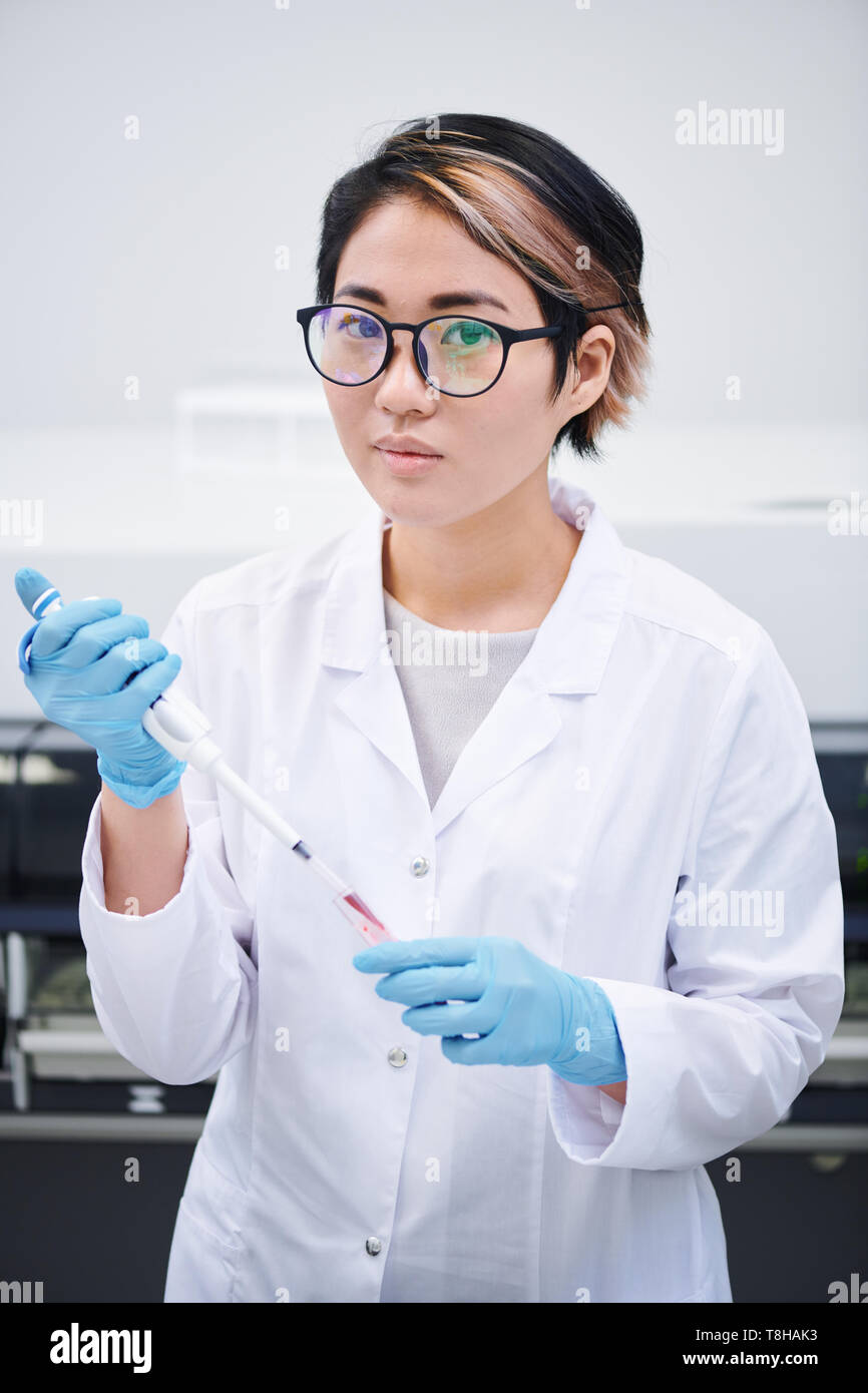 Young lab technician preparing sample for research Stock Photo - Alamy