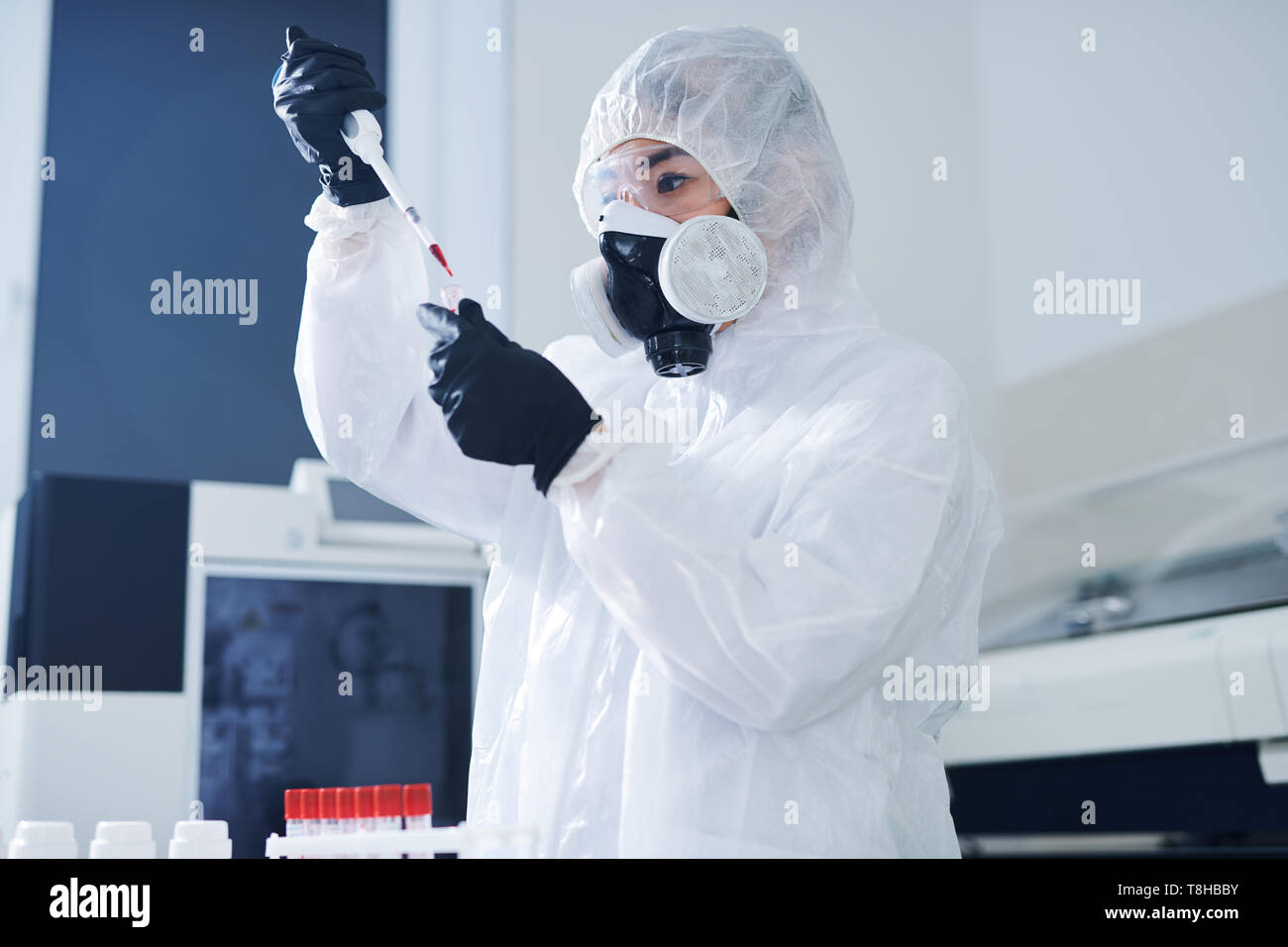Concentrated healthcare scientist testing virus sample Stock Photo - Alamy