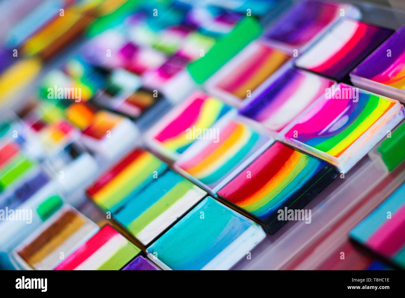A colourful pellet of face paints are spread out during a painting ...