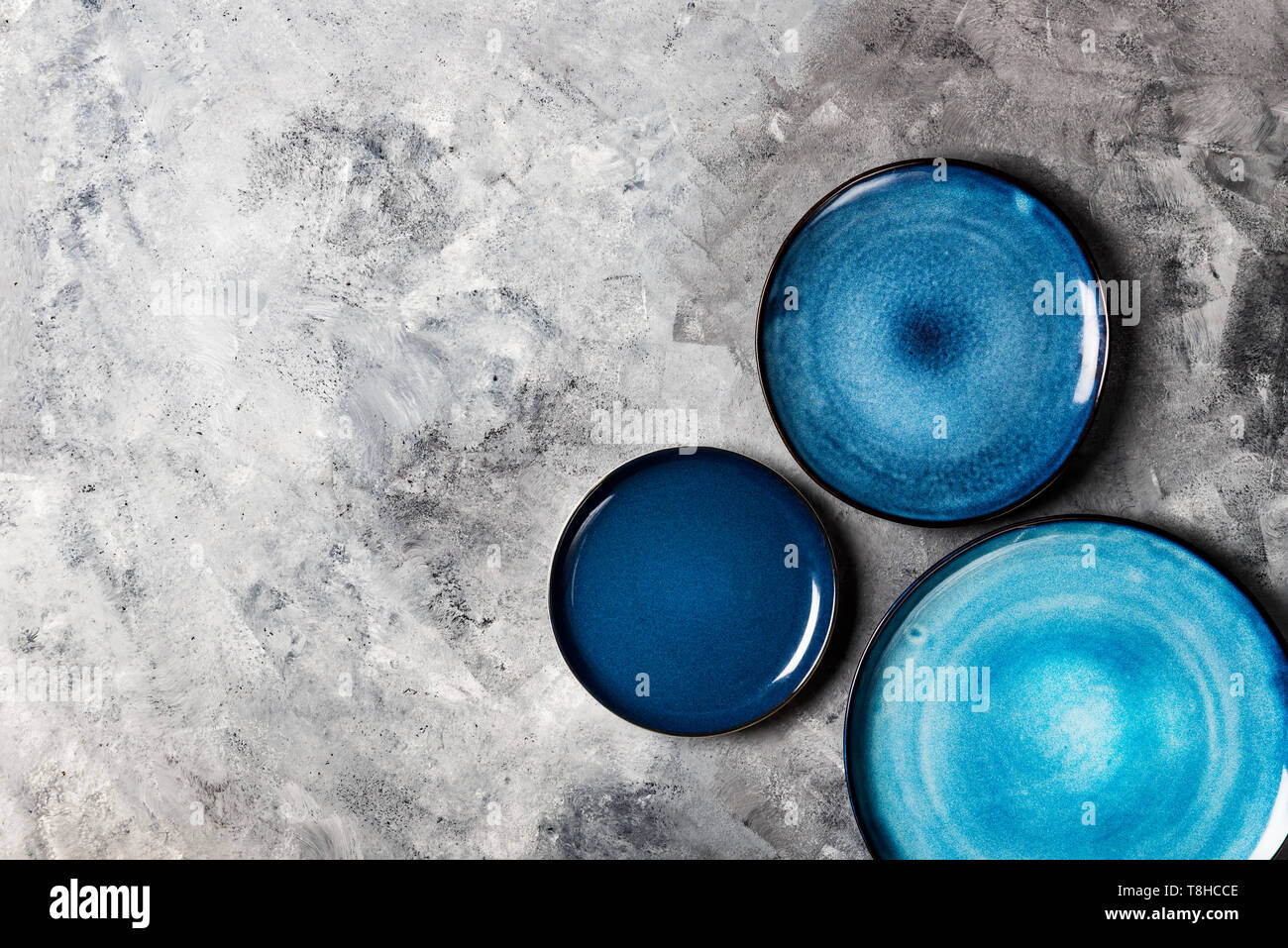 Empty Blue Plates on Grey Background Stock Photo - Alamy