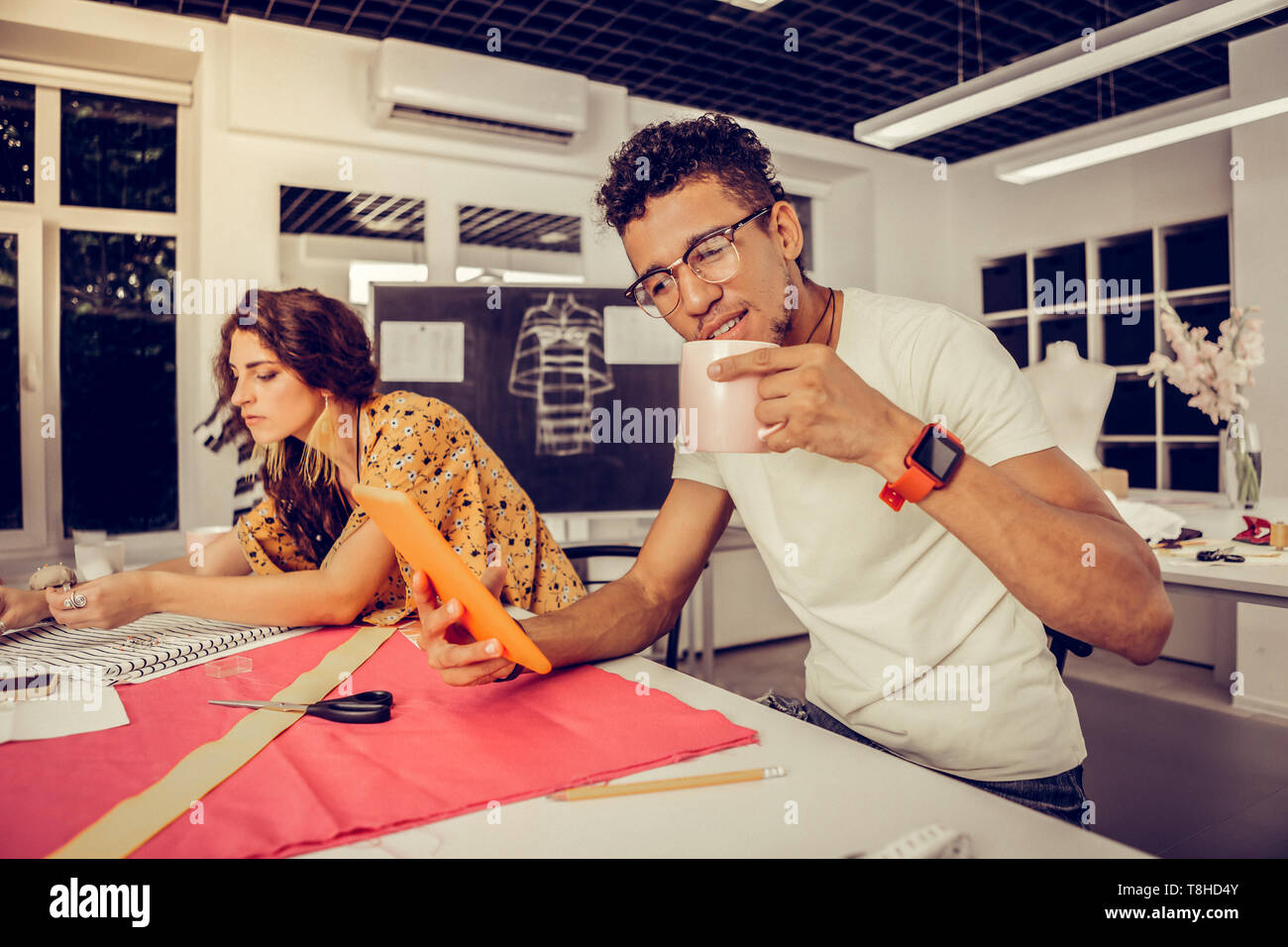 Hardworking dress-designers working in studio at night Stock Photo - Alamy