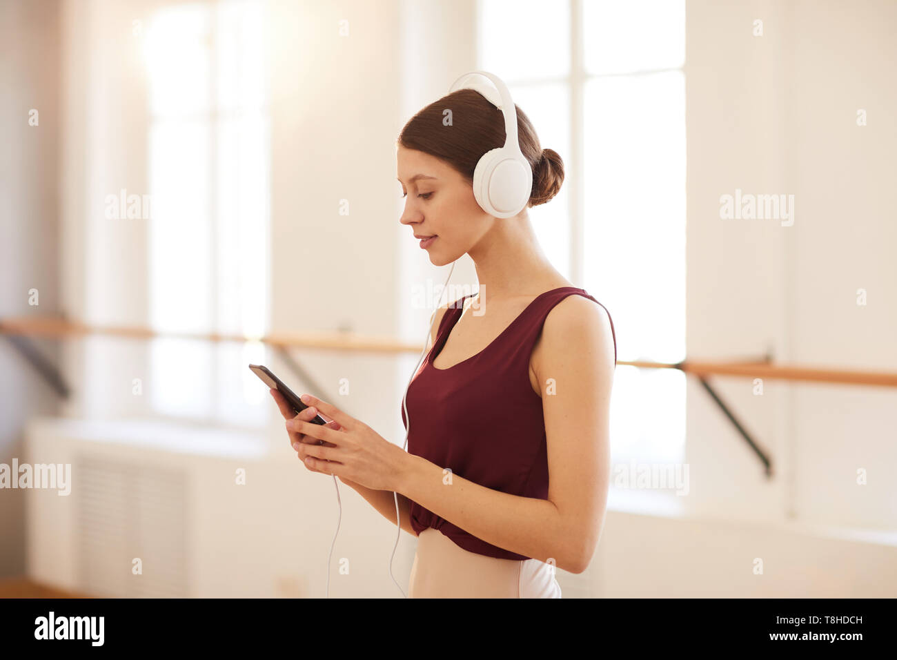 Pretty girl choosing track for training Stock Photo - Alamy
