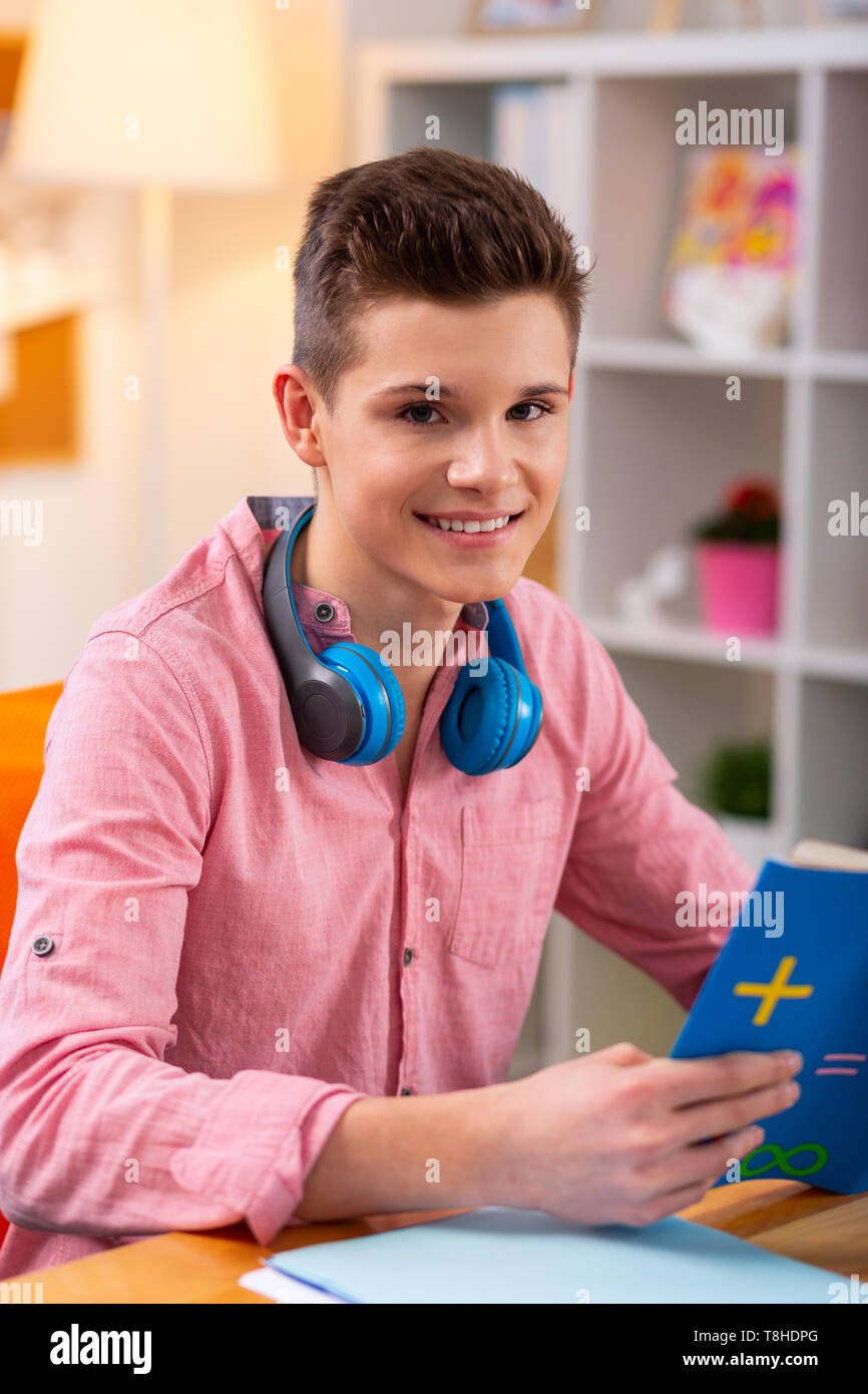 Handsome teenager feeling good after reading interesting book Stock ...