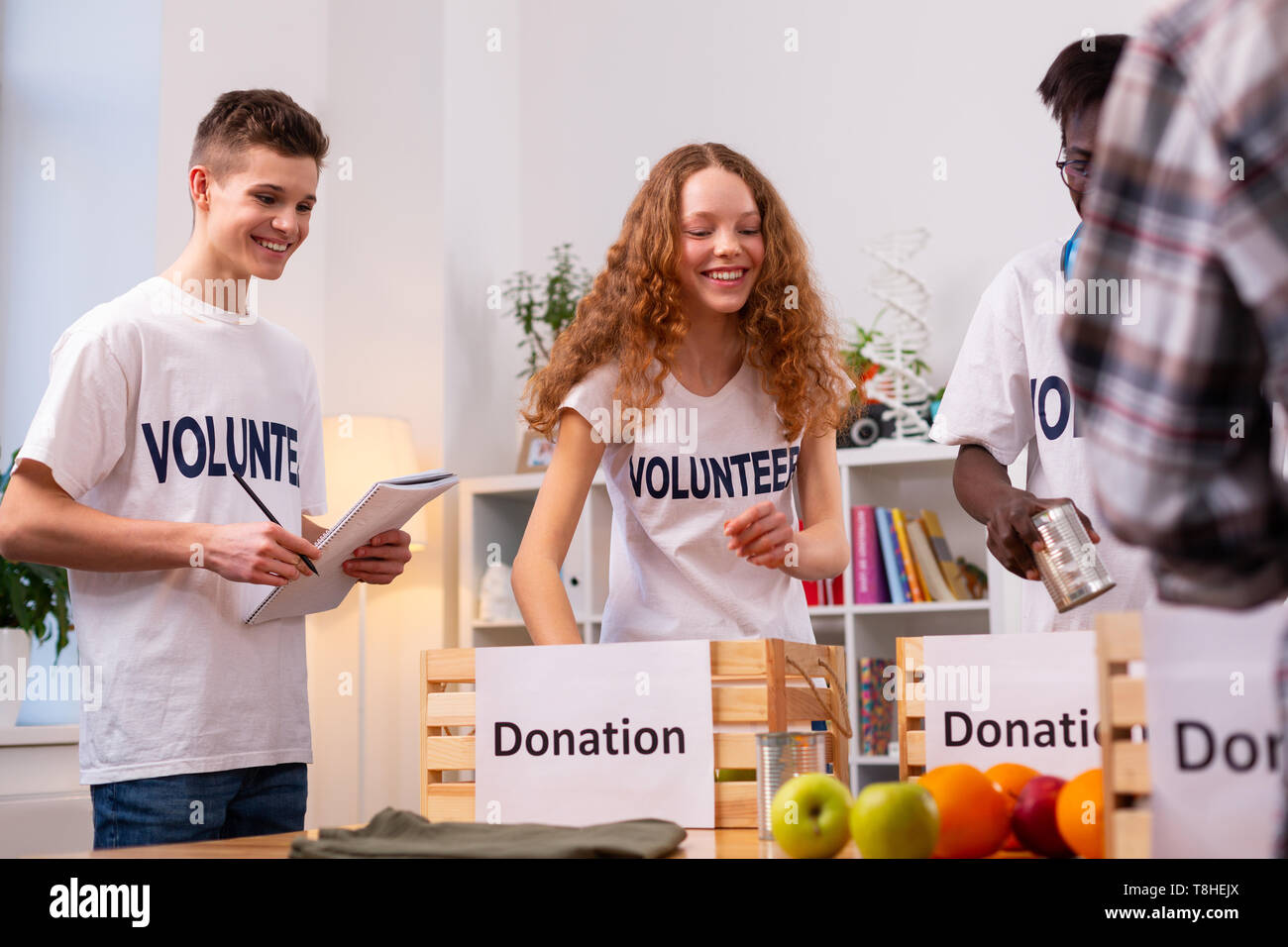 Volunteers gathering items for donation to people in need Stock Photo ...