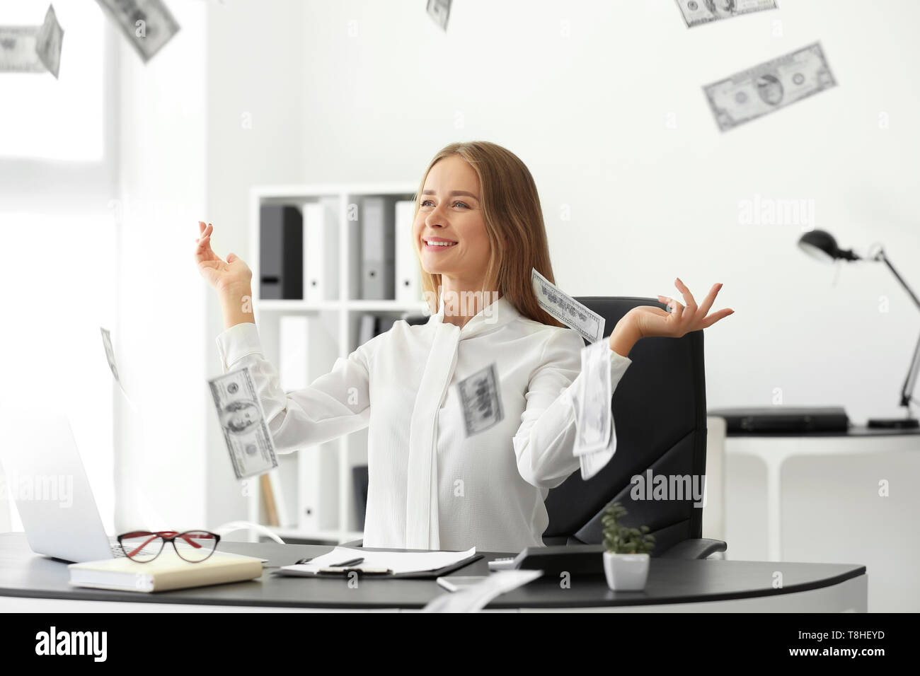 Successful businesswoman with lot of money in office Stock Photo - Alamy
