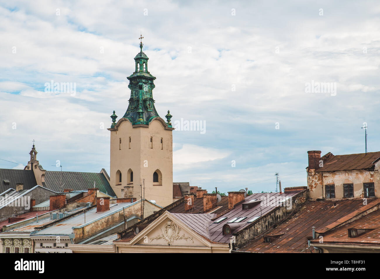 church tower over old building roofs. overcast weather. copy space ...