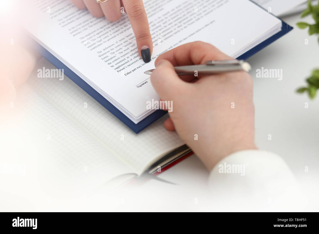 Arm fill and sign important form clipped to pad Stock Photo - Alamy