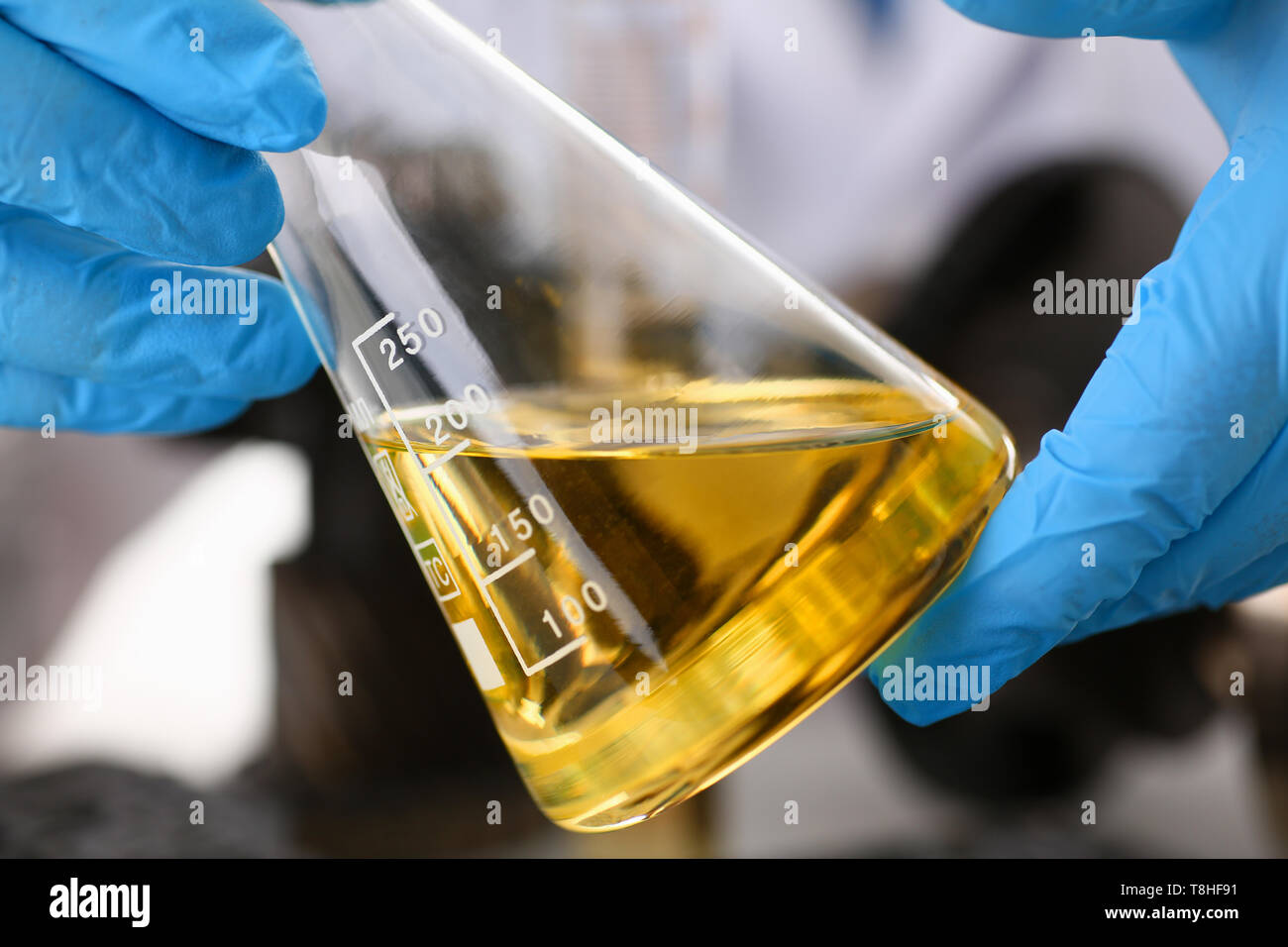 Male hands in protective gloves hold test tube Stock Photo - Alamy