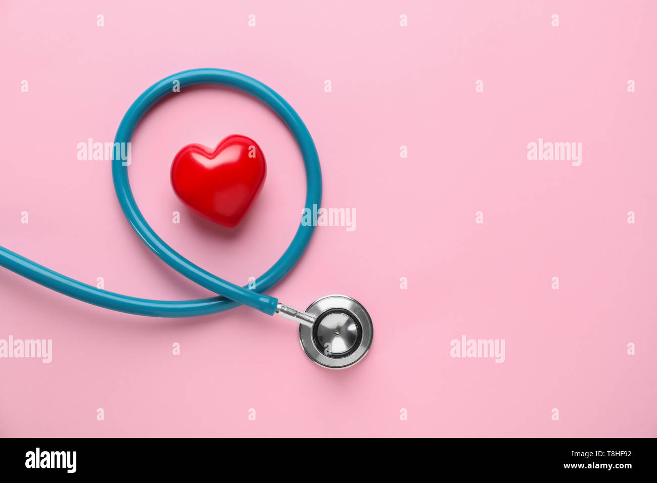 Medical stethoscope and red heart on color background. Cardiology ...