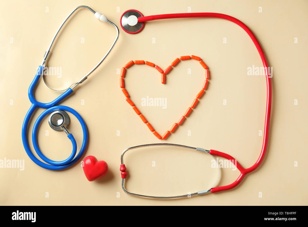 Medical Stethoscopes Pills And Red Heart On Light Background