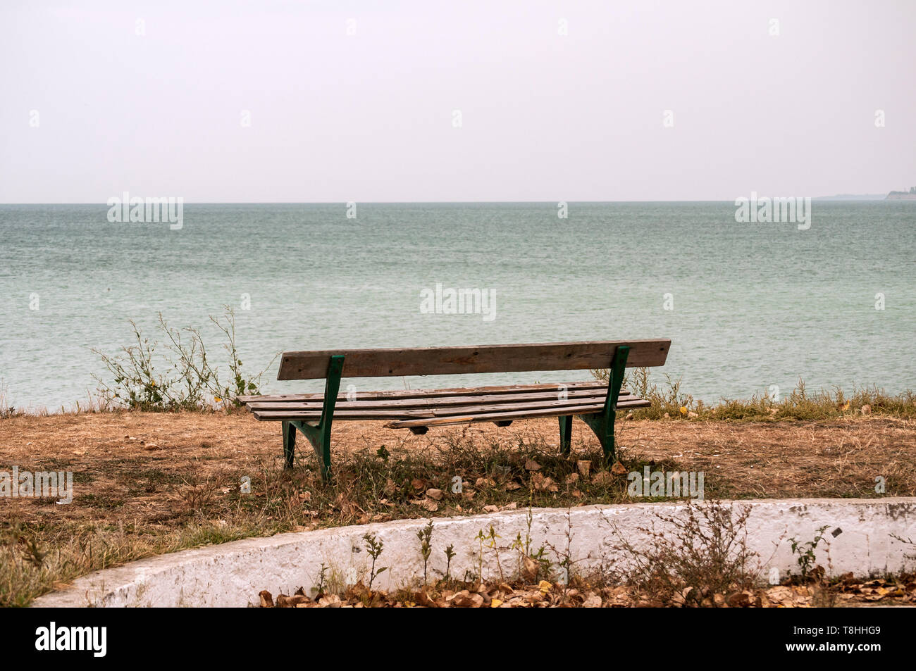Lonely empty wooden obsolete vintage bench on the seashore Stock Photo ...