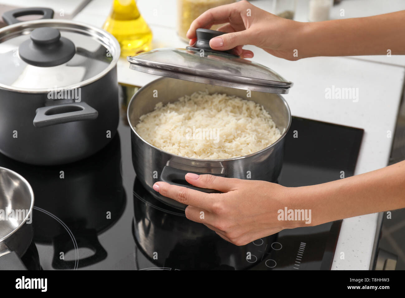 Woman cooking rice in pot hi-res stock photography and images - Alamy