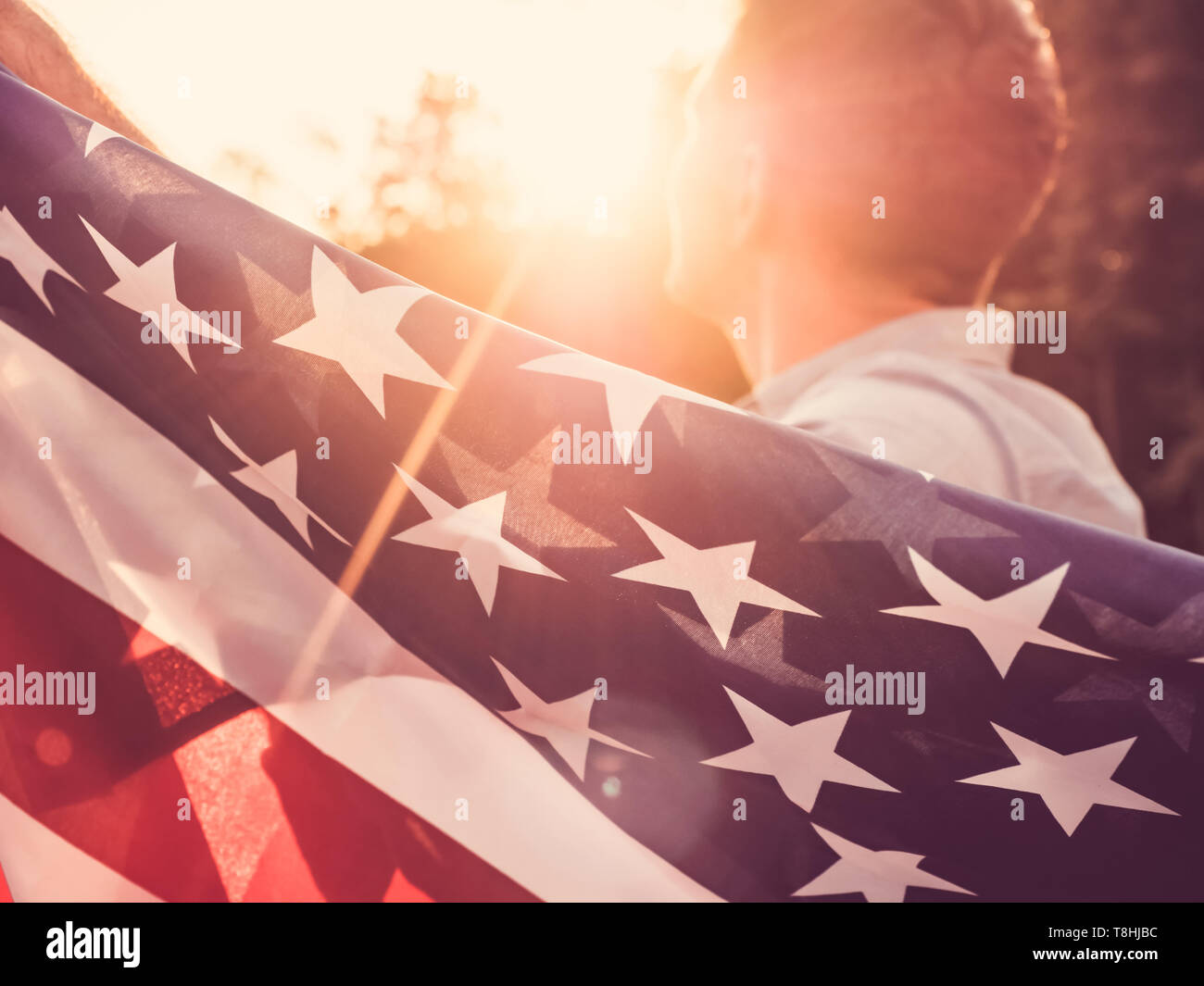 Handsome, young man waving an American flag Stock Photo - Alamy