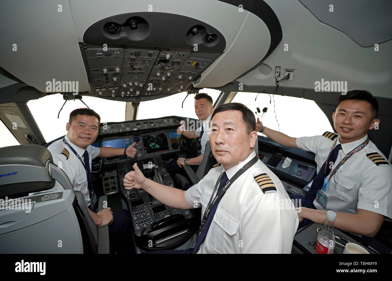 Beijing, China. 13th May, 2019. Crew members of Xiamen Airlines gesture ...