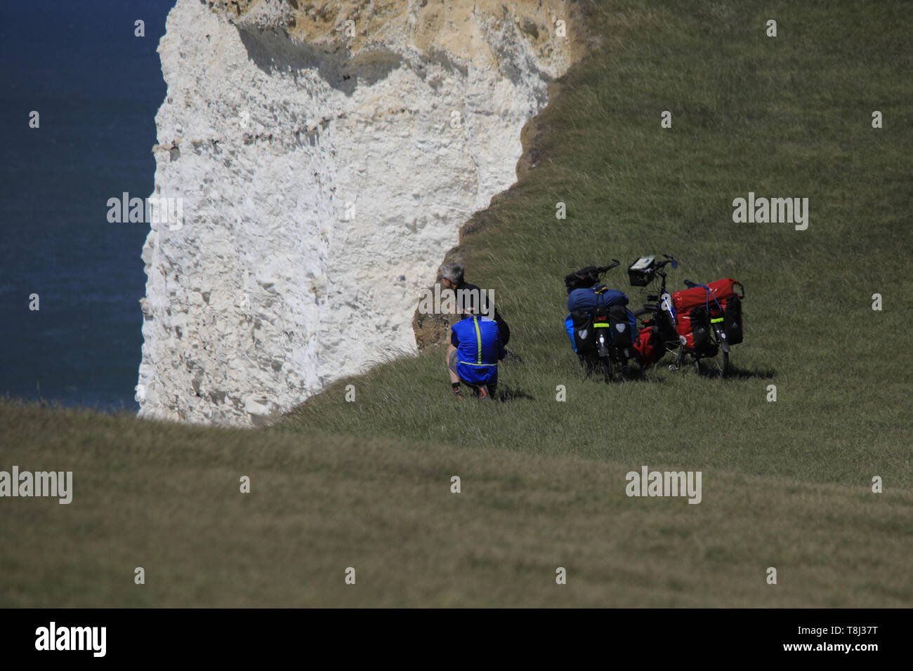 Beachy Head, UK. 14th May 2019. A pair of cyclists pose for pictures ...