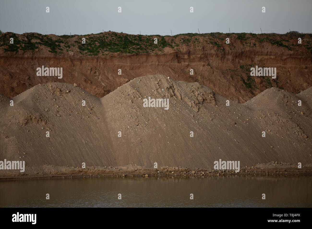 Small pond in the middle of pebble quarry Stock Photo - Alamy