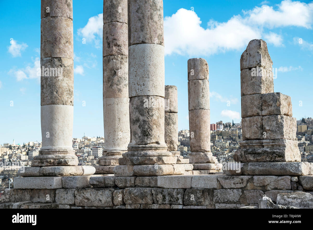 Cityscape view through the columns of Hercules Temple, Amman Citadel ...