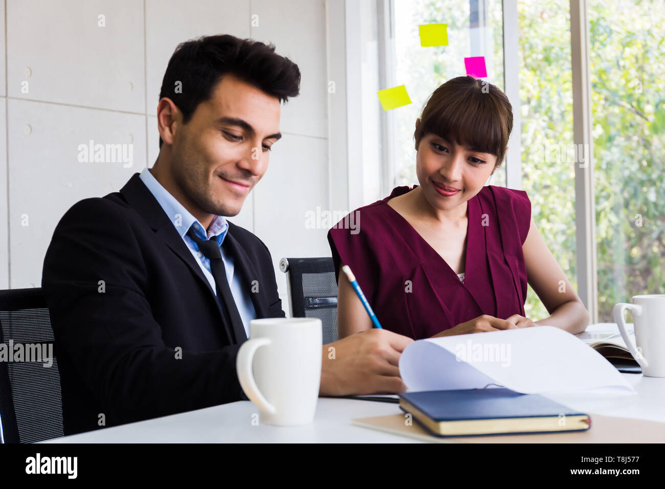Asian business woman and Caucasian business man as colleagues taking ...
