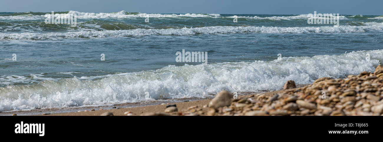 the ocean near tel aviv in israel with waves and rocks on the beach ...