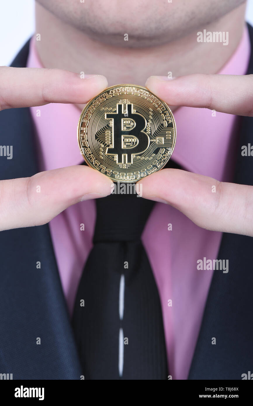 Man holding golden Bitcoin isolated on white background. High ...