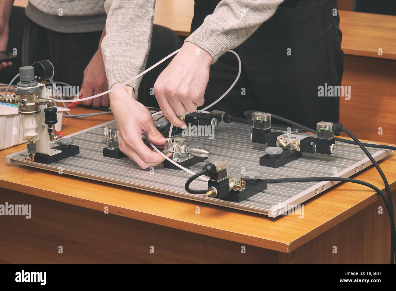 Engineers connect wires control panel with a small test bench for ...