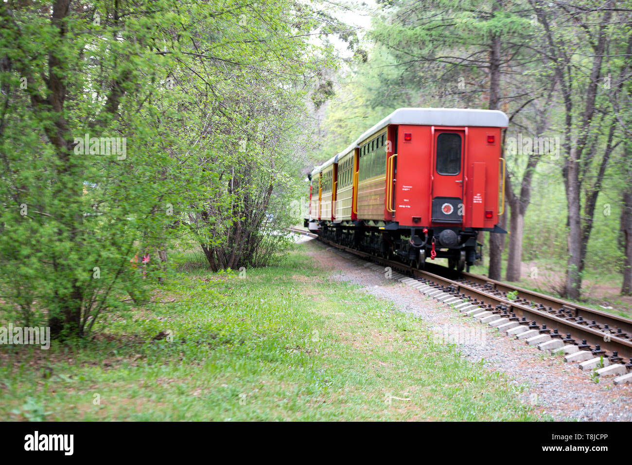 The back of the train with a red carriage at the end of the road ...