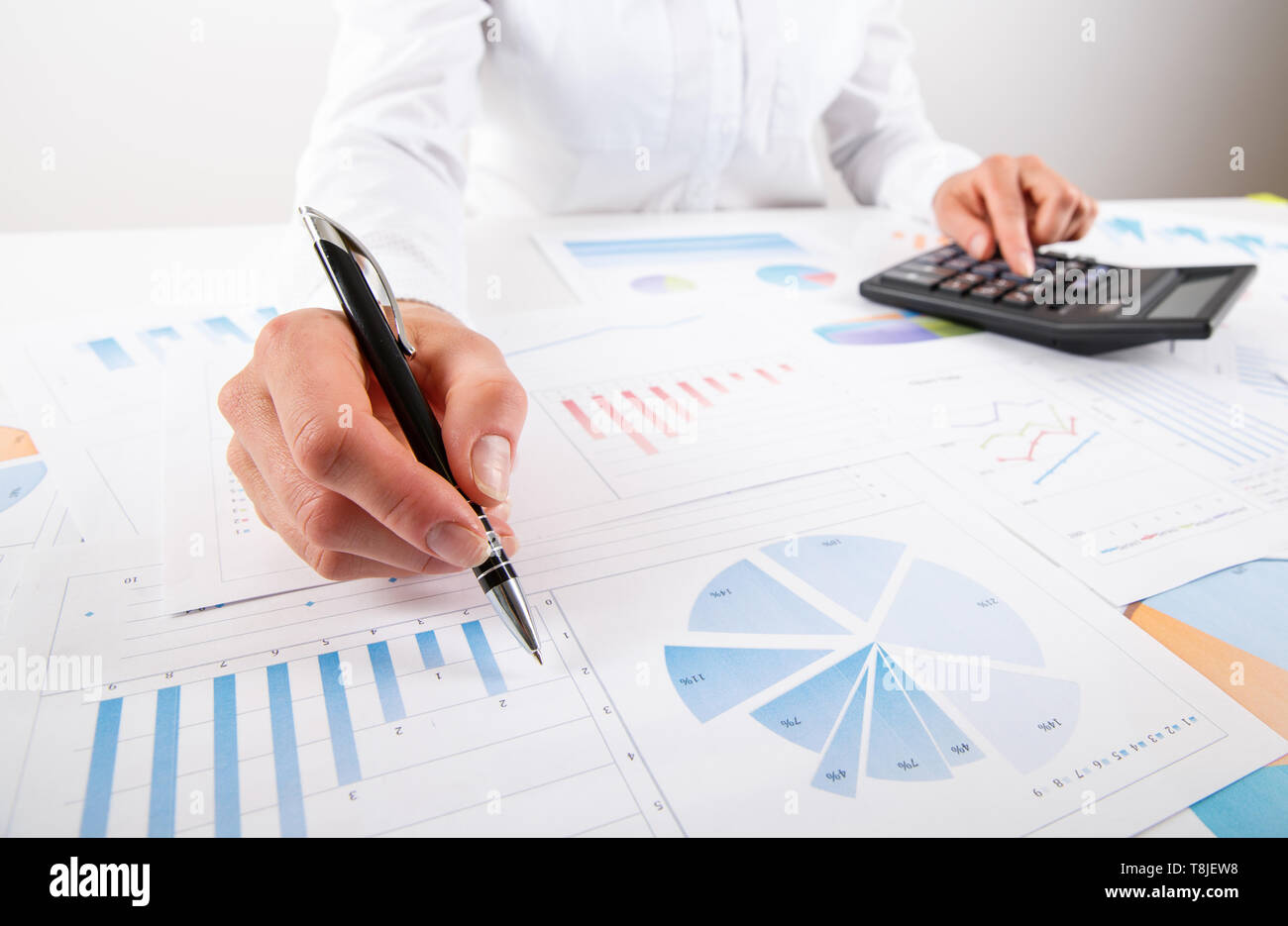 Business woman pointing at graph document close-up Stock Photo - Alamy