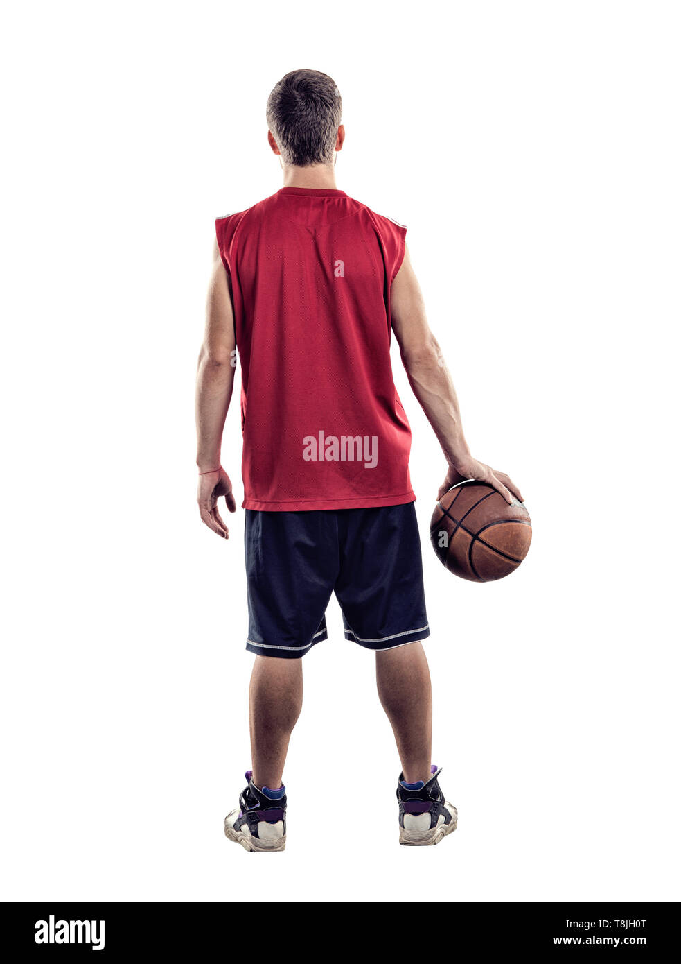 Basketball player standing back to camera with ball in hand isolated on ...
