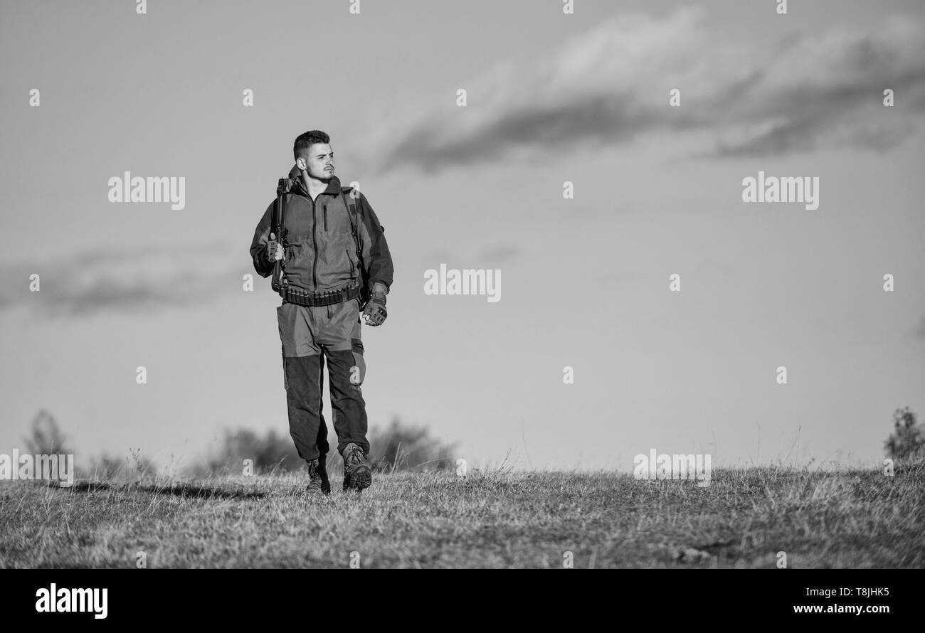 Man hunter carry rifle blue sky background. Experience and practice ...