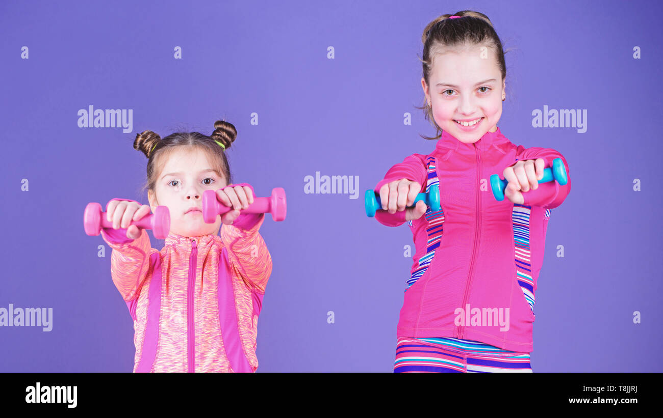 Strong and healthy. Cute sisters have physical training of muscular ...