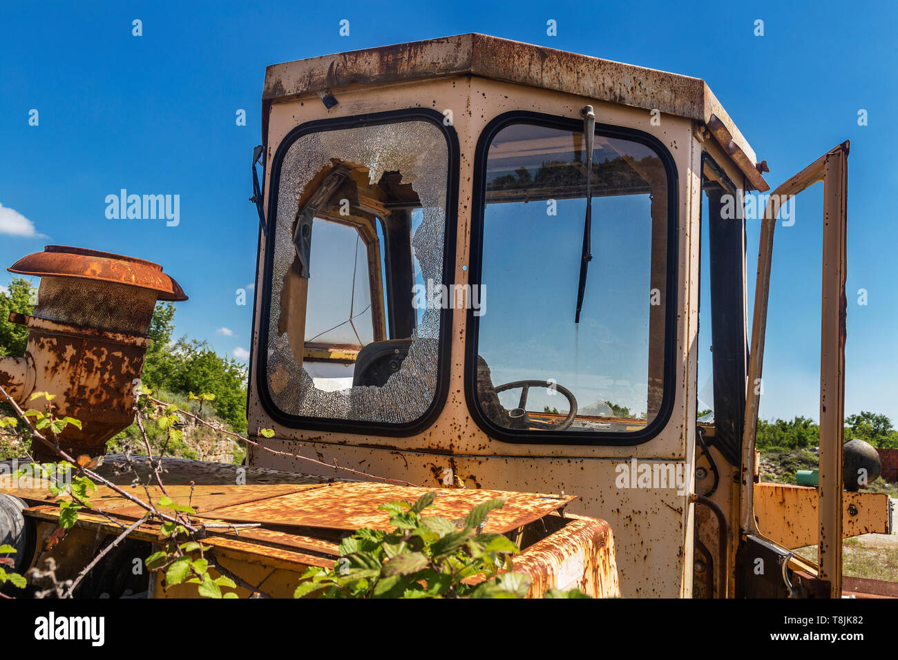 old yellow cracked and abandoned excavator Stock Photo - Alamy