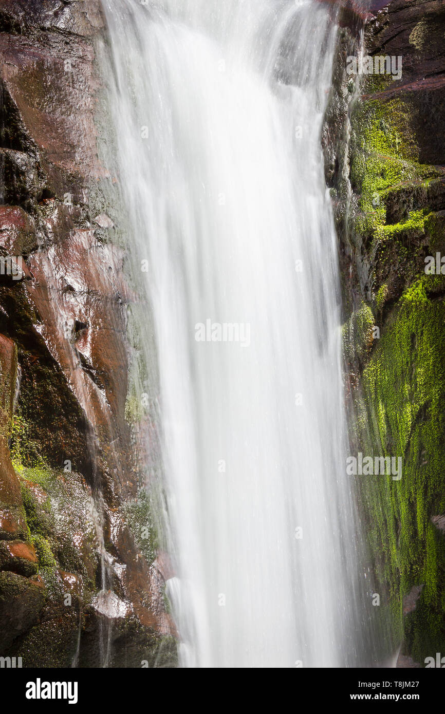 Unique, close up view of a scenic waterfall during spring streaming ...