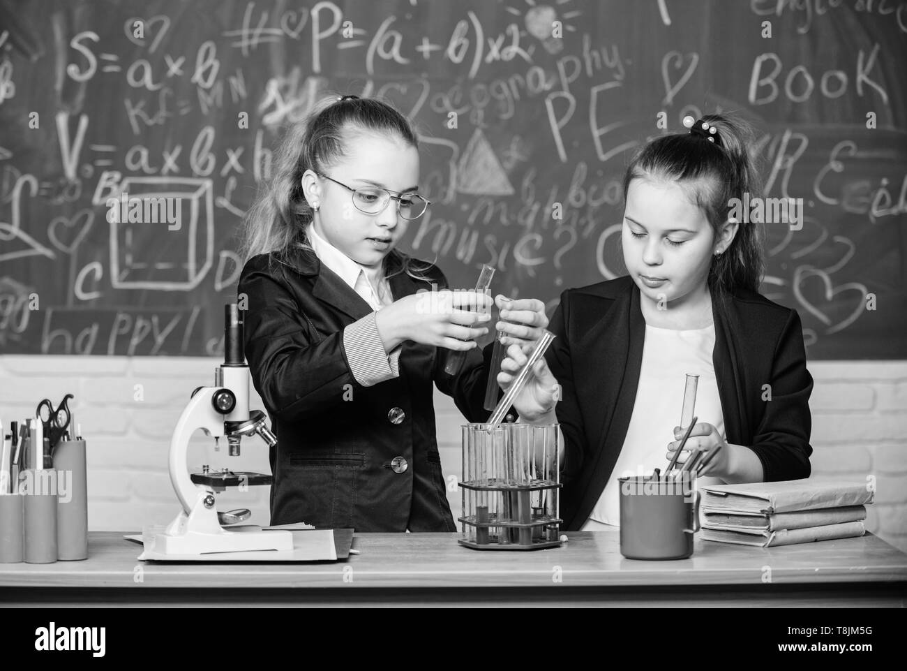 Confident medical experts. Little girls in school lab. Formal school ...