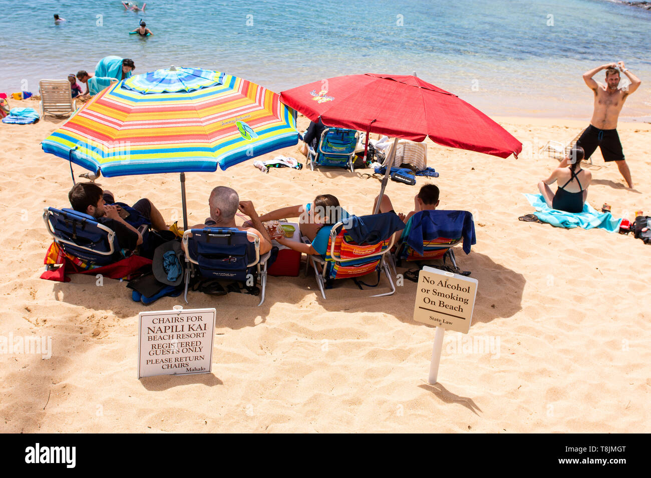 Two friends under beach umbrellas hi-res stock photography and images ...