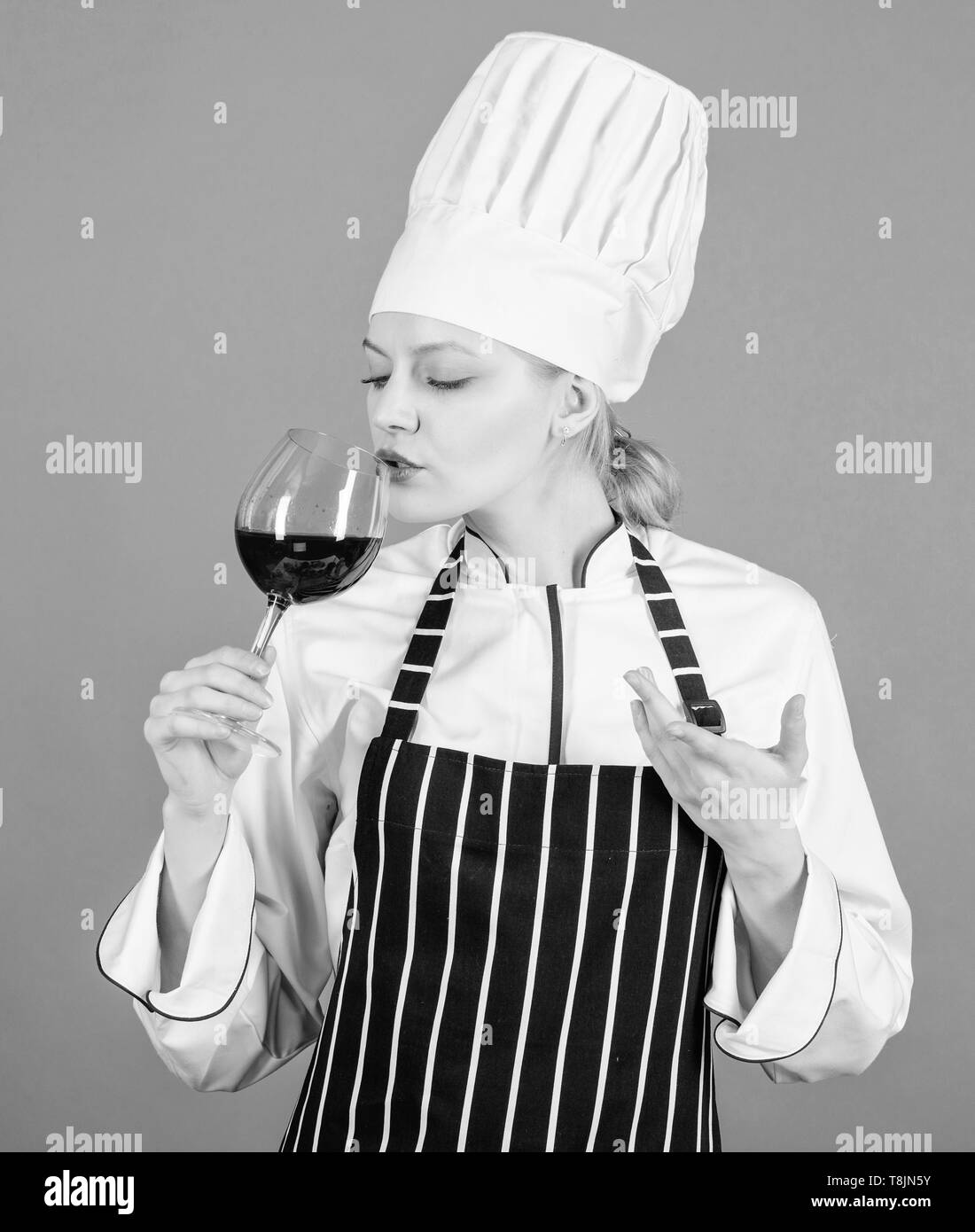Woman professional chef hold glass of wine. Restaurant concept. Wine ...