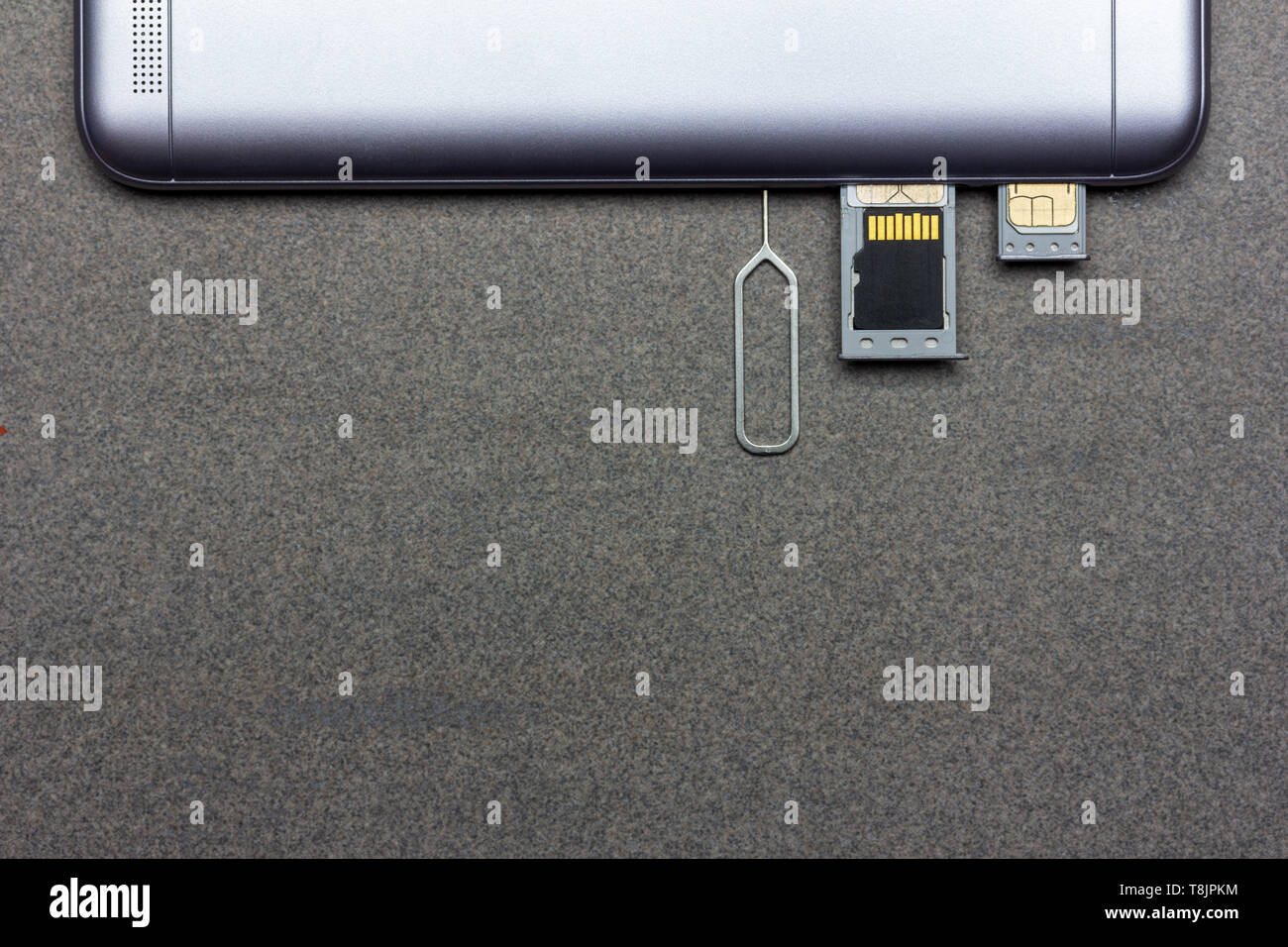 smartphone with open slots with SIM cards and micro SD memory on gray ...