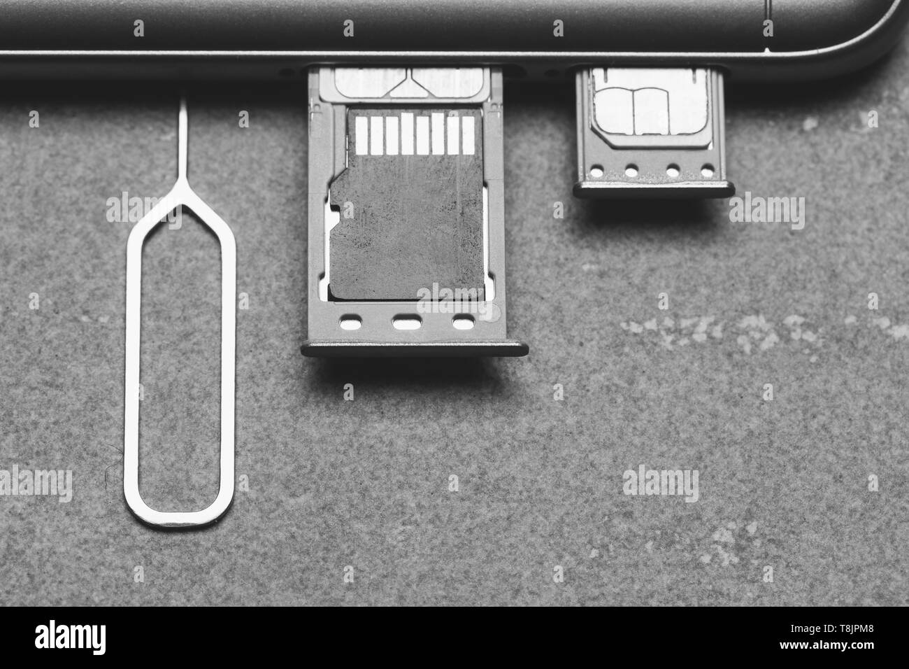 Smartphone with open SIM slots and micro SD memory on a gray background ...