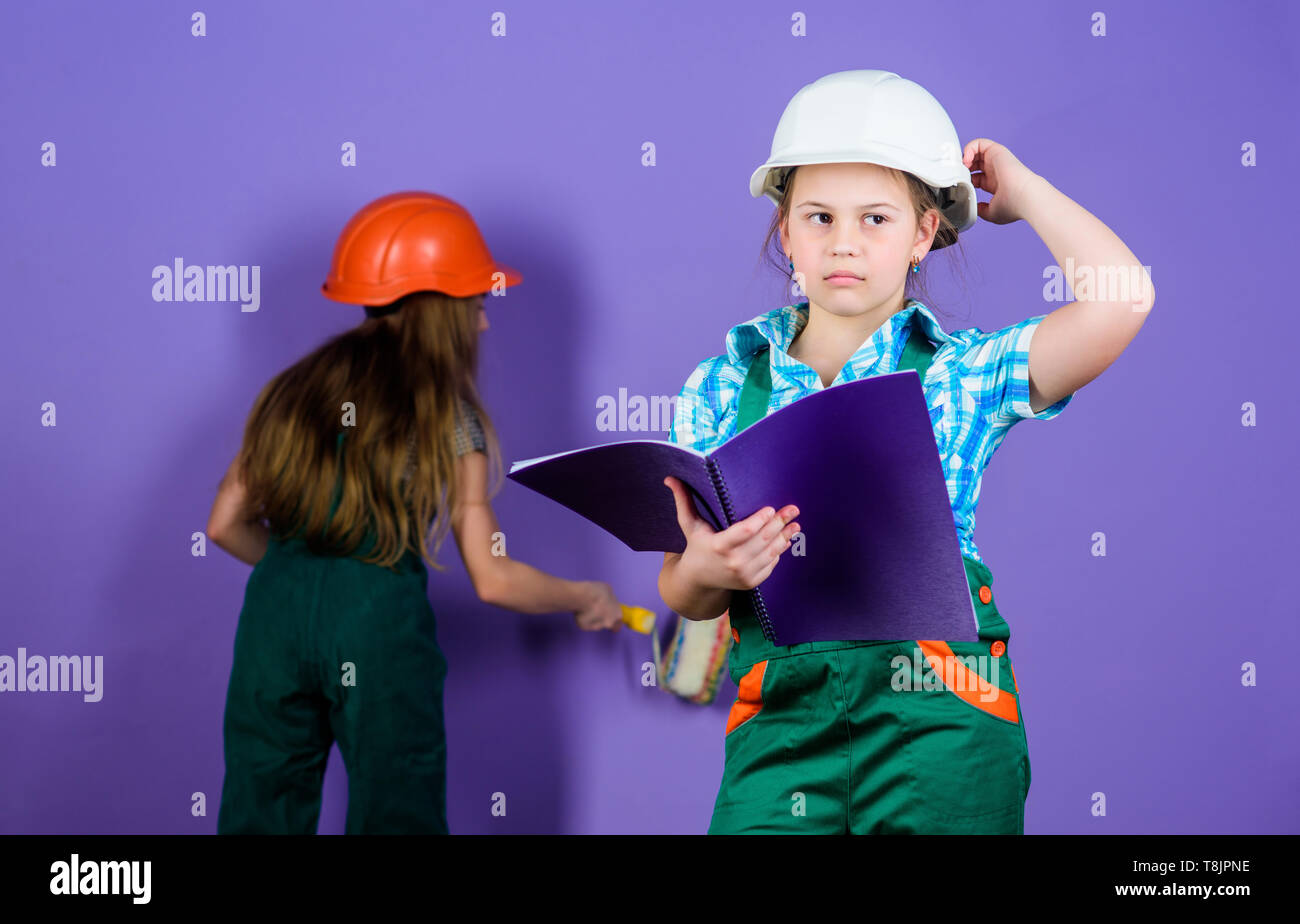 small girls repairing together in workshop. Labor day. 1 may ...