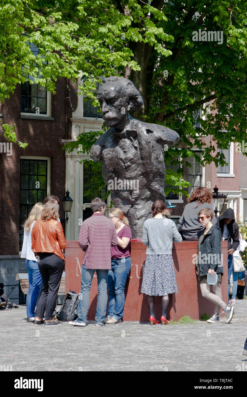 Tourists gather around the statue of Multatuli in Amsterdam Stock Photo ...