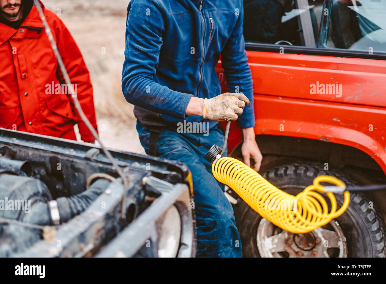 A man pumps air wheel with a compressor Stock Photo - Alamy