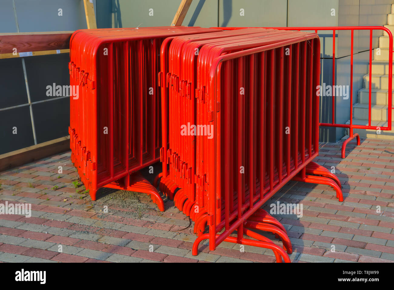 A stack of metal traffic barriers of red color on the stadium Stock ...