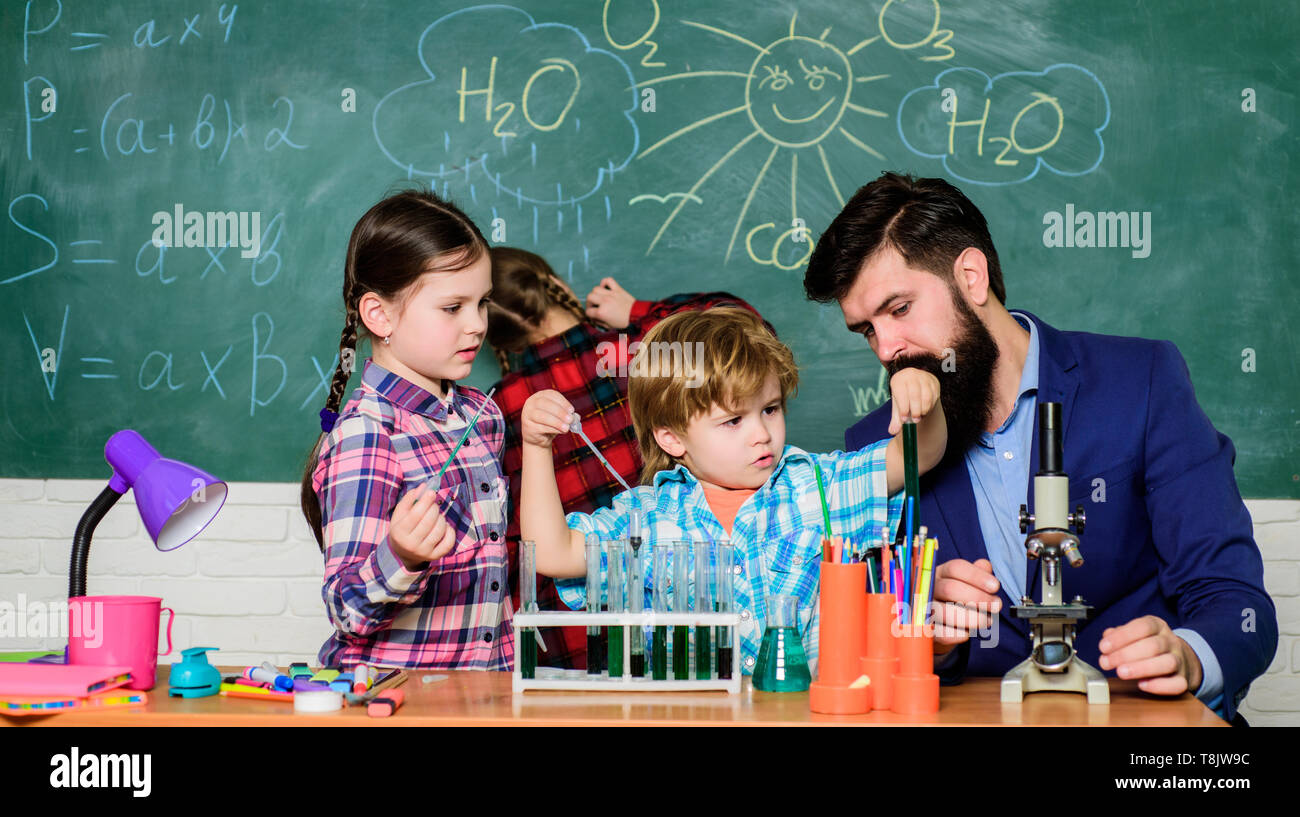 students doing science experiments with microscope in lab. school kids ...