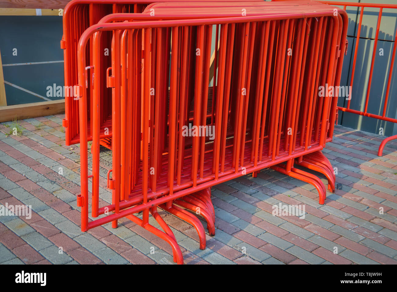 A stack of metal traffic barriers of red color on the stadium Stock ...
