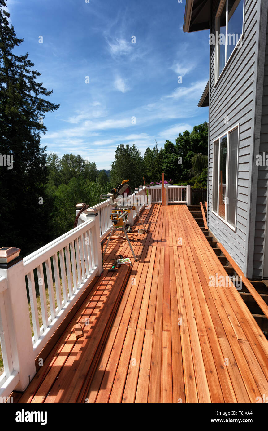 Side view of an outdoor wooden deck being completely remodeled during ...