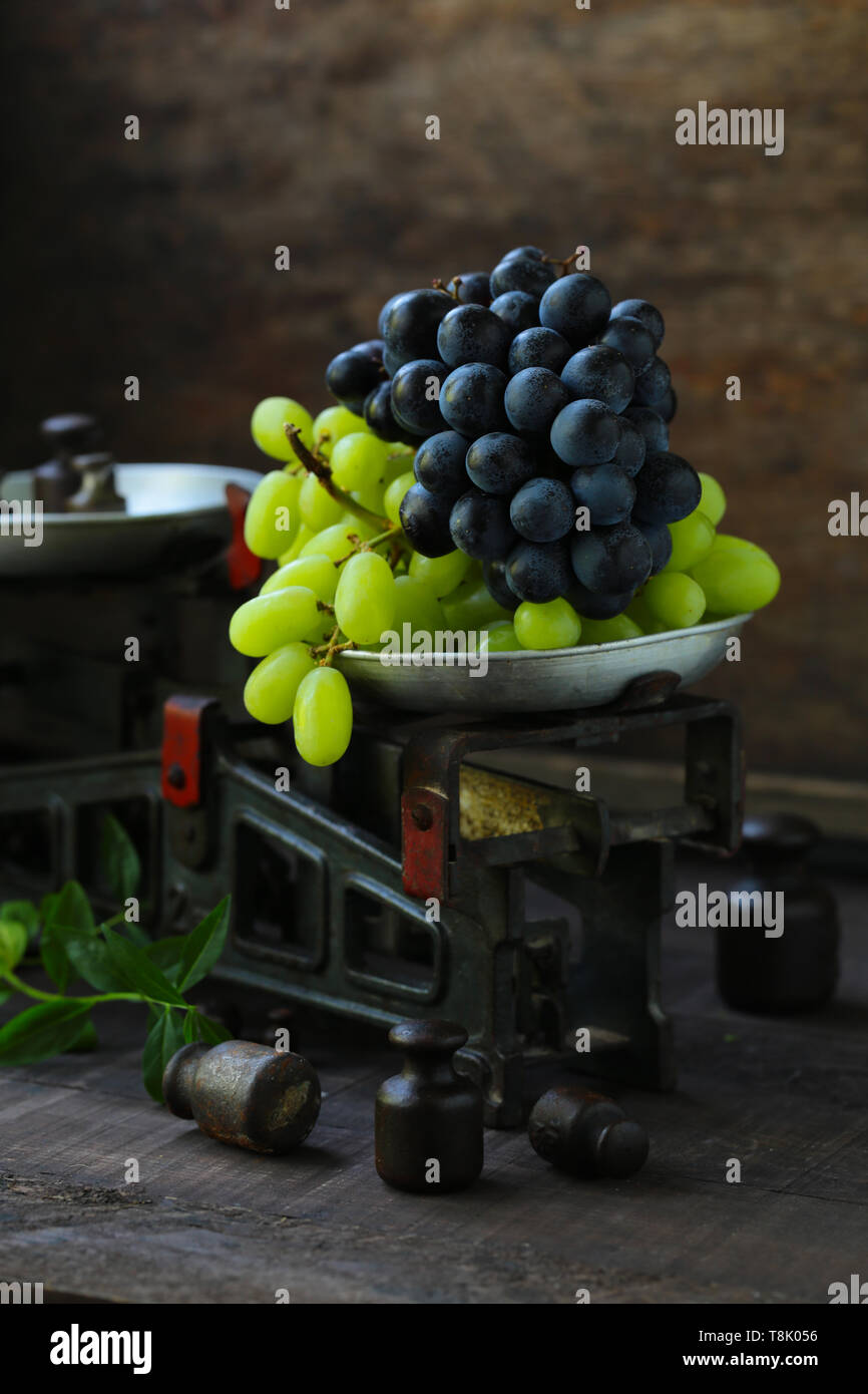 organic ripe grapes on scales, rustic style Stock Photo - Alamy